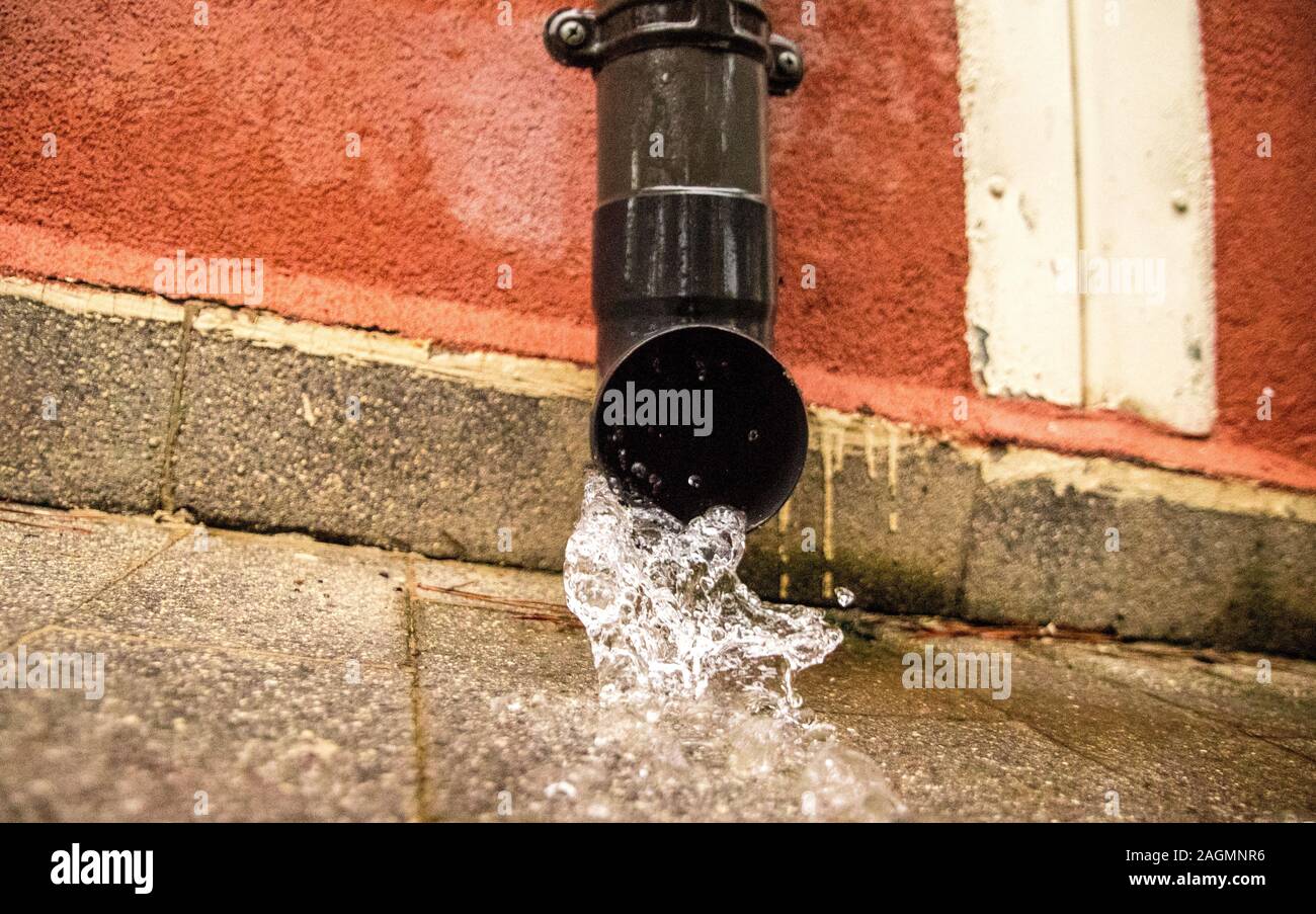 Gutters gush with water from a heavy downpour of rain Stock Photo - Alamy