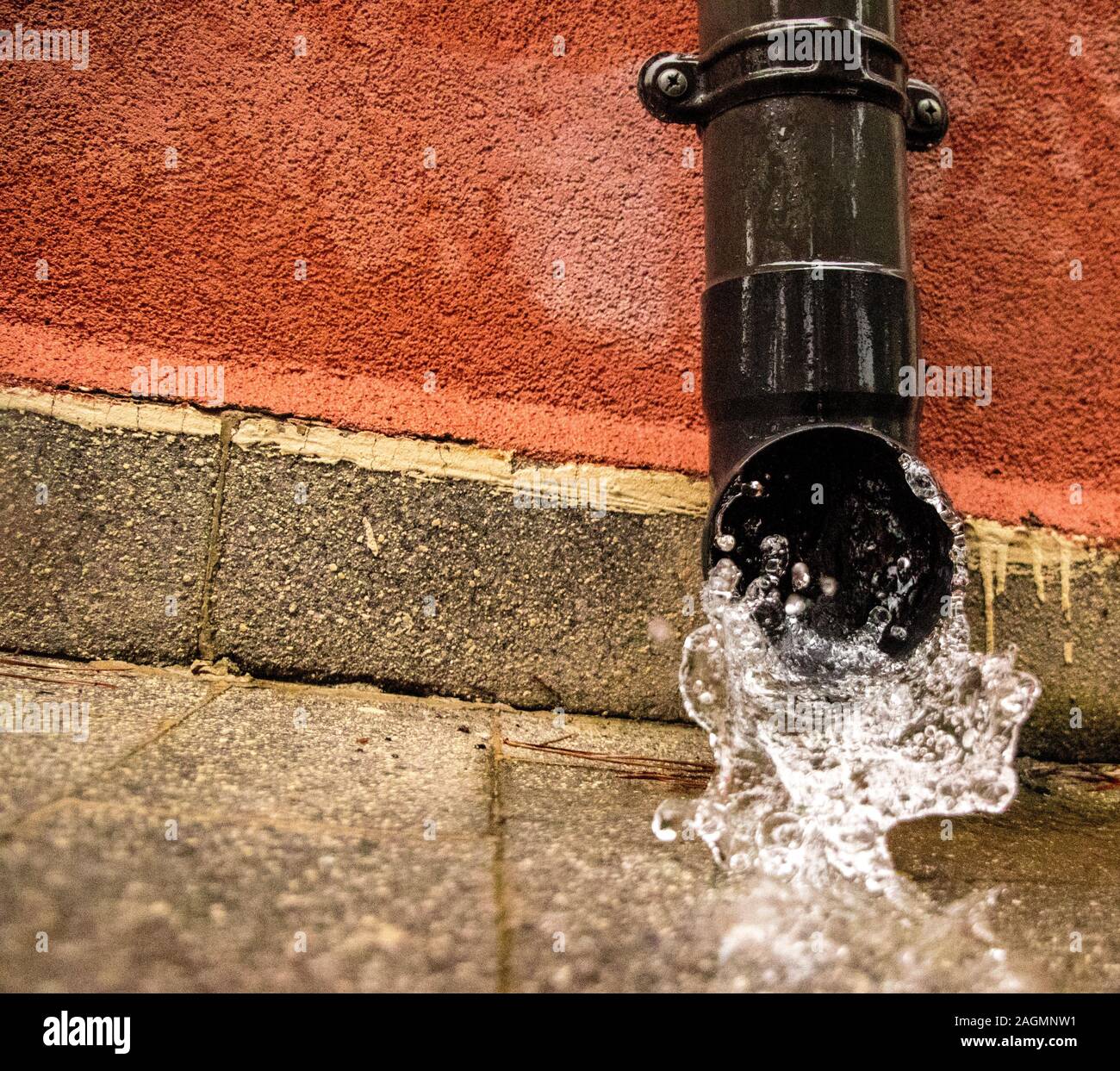 Gutters gush with water from a heavy downpour of rain Stock Photo - Alamy