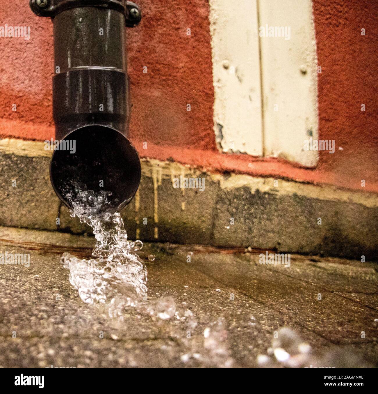 Gutters gush with water from a heavy downpour of rain Stock Photo - Alamy