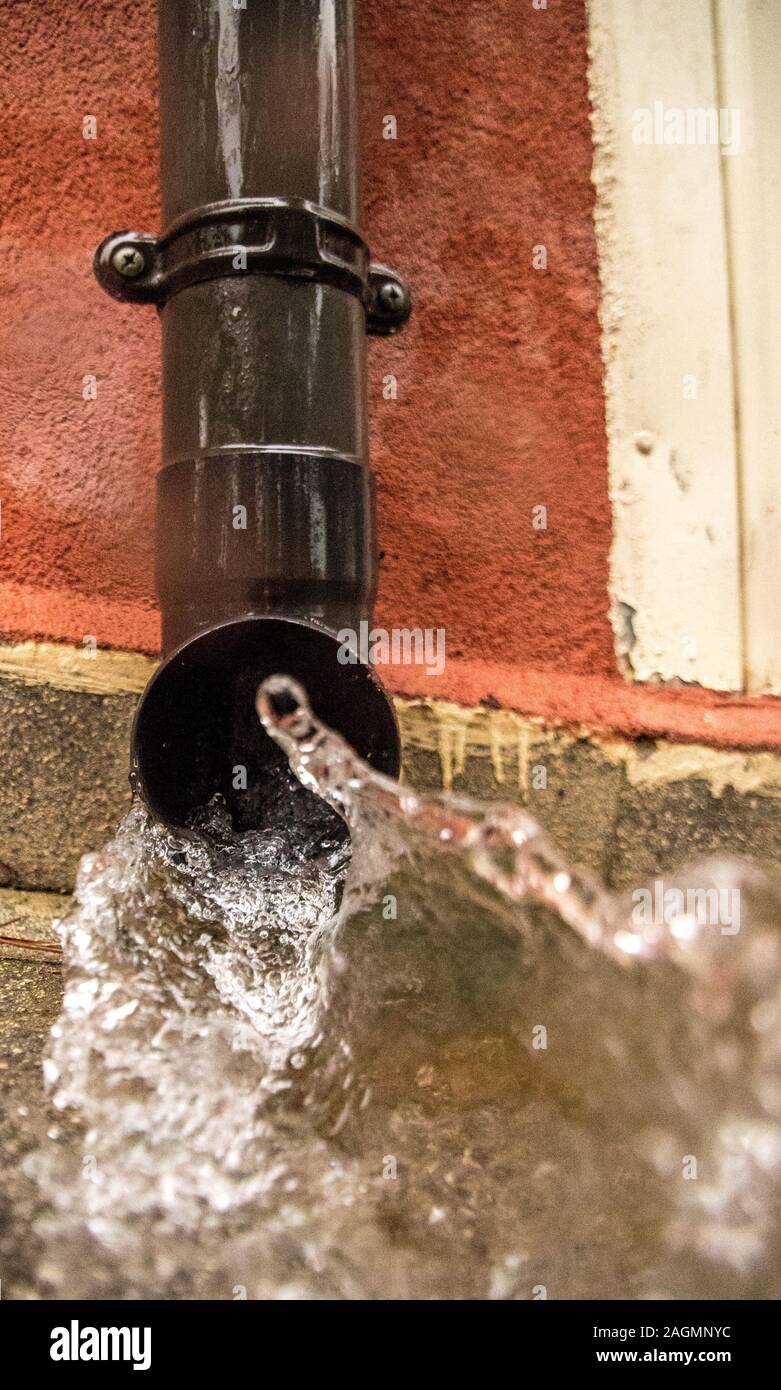 Gutters gush with water from a heavy downpour of rain Stock Photo - Alamy