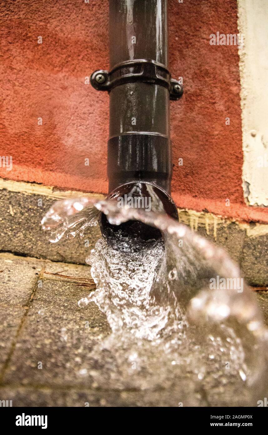 Gutters gush with water from a heavy downpour of rain Stock Photo - Alamy