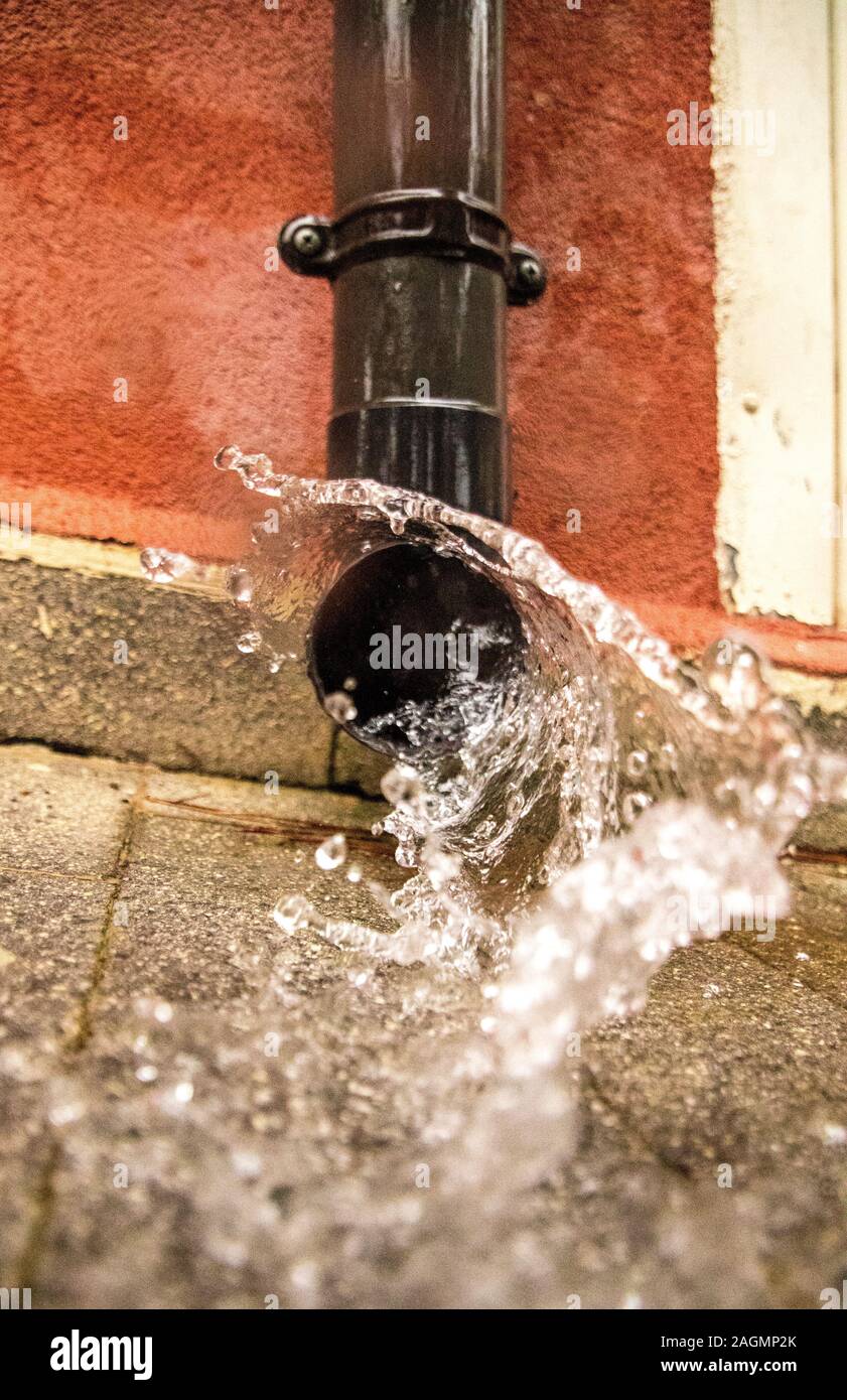 Gutters gush with water from a heavy downpour of rain Stock Photo - Alamy