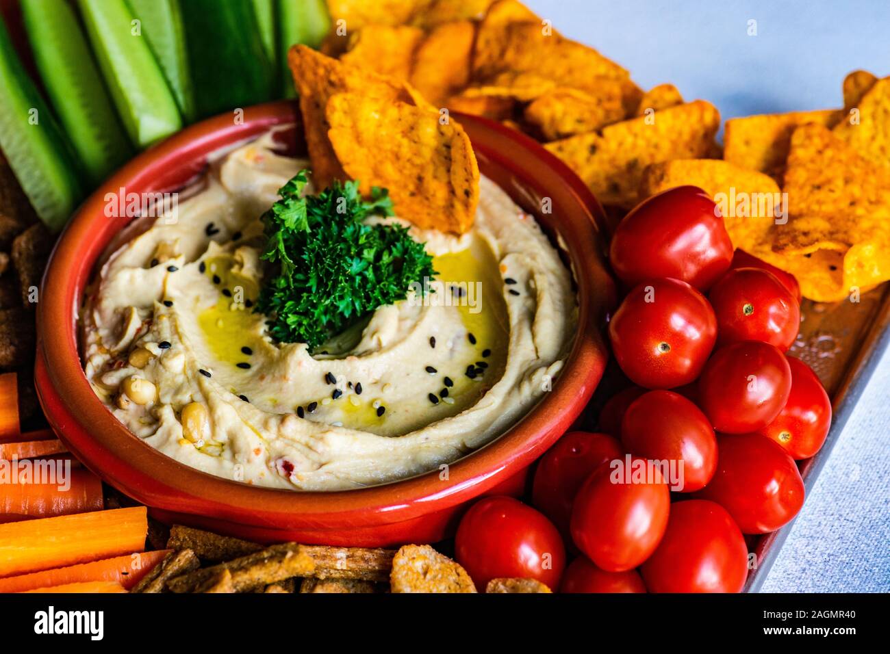 Traditional chickpeas hummus with olive oil and sesame seeds on stone ...