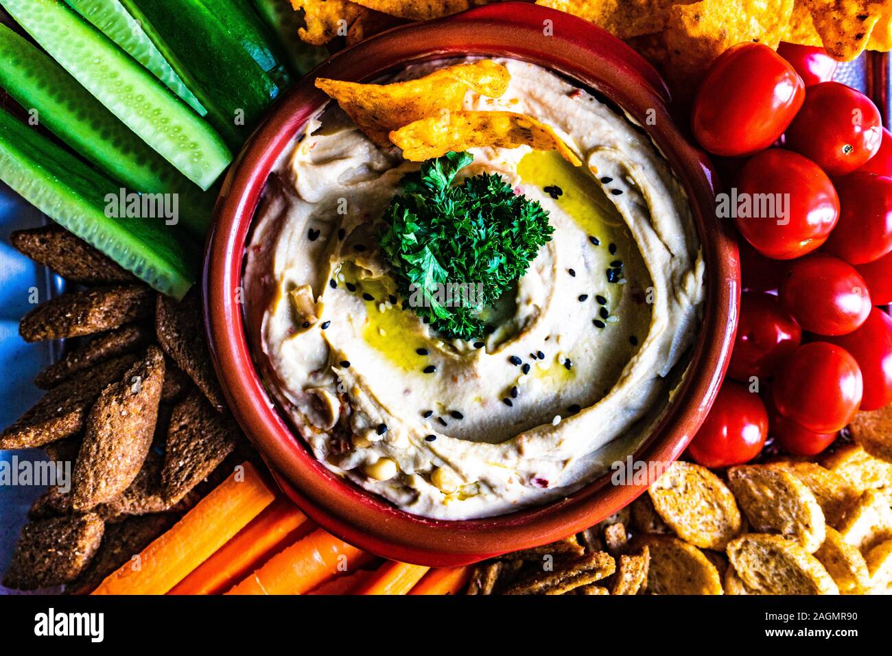 Traditional chickpeas hummus with olive oil and sesame seeds on stone ...