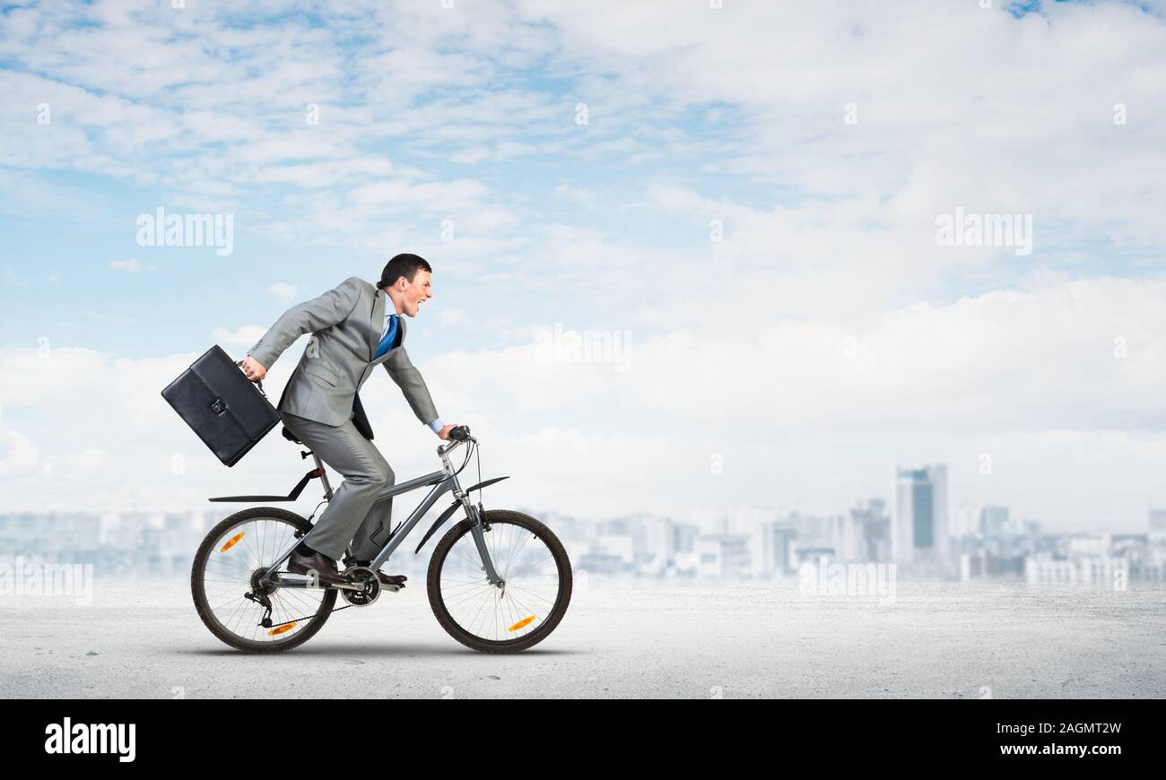 Man wearing business suit riding bicycle outdoor Stock Photo - Alamy