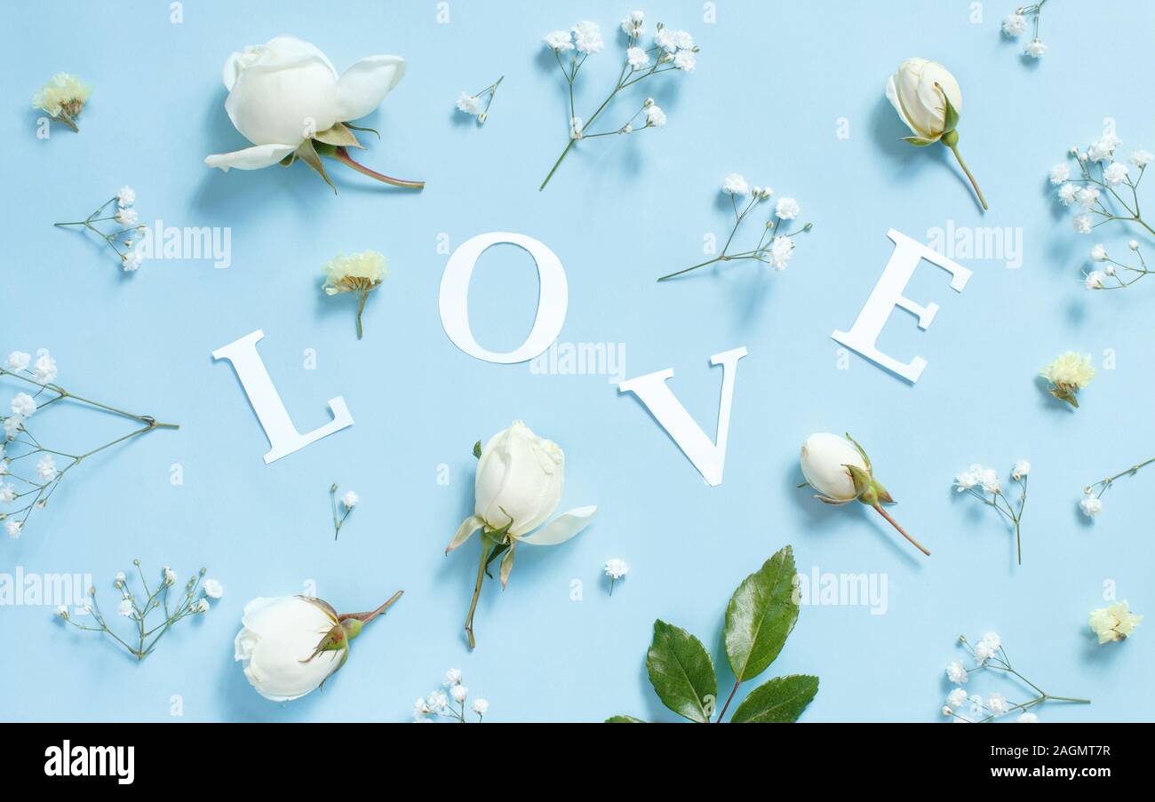 Flowers and word LOVE on a light blue background top view Stock Photo ...