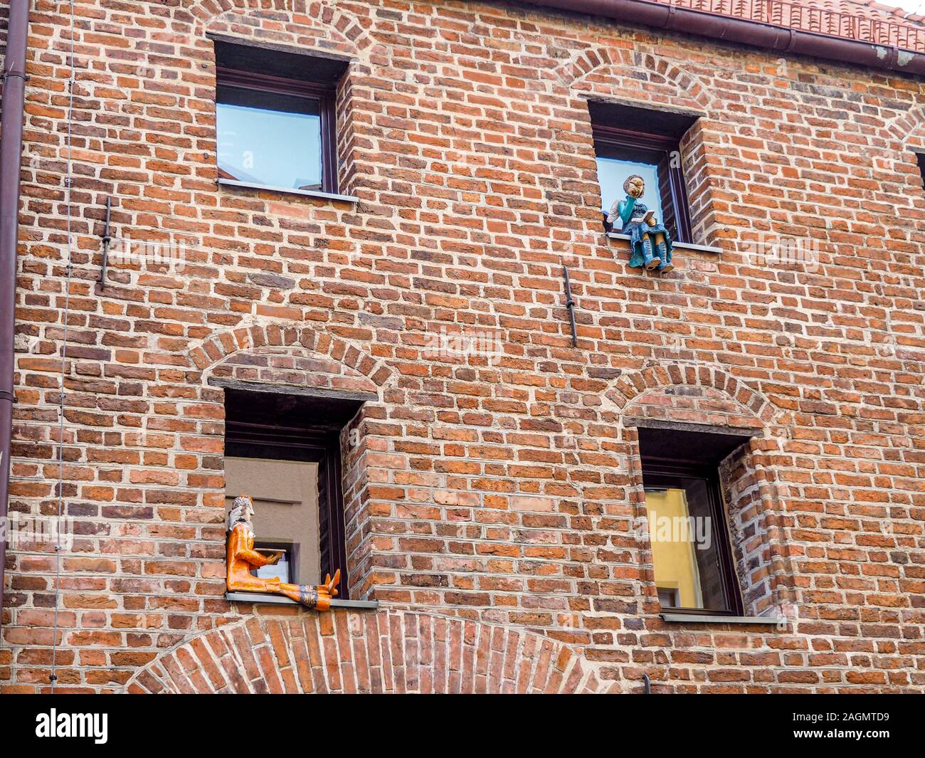 Folk art figures on walls and windowsills in medieval town of Torun ...