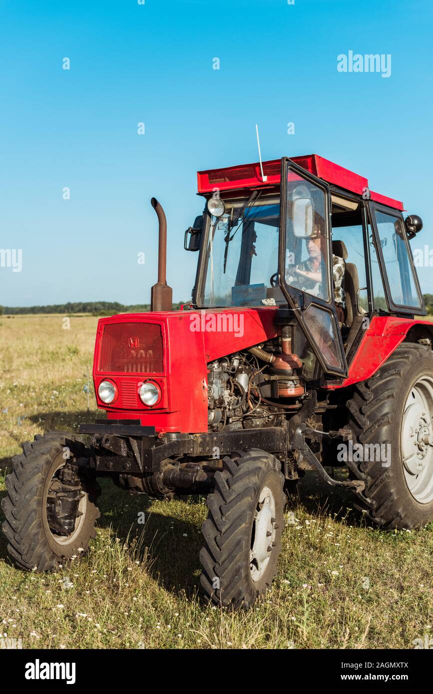 Farmer driving red tractor hi-res stock photography and images - Alamy
