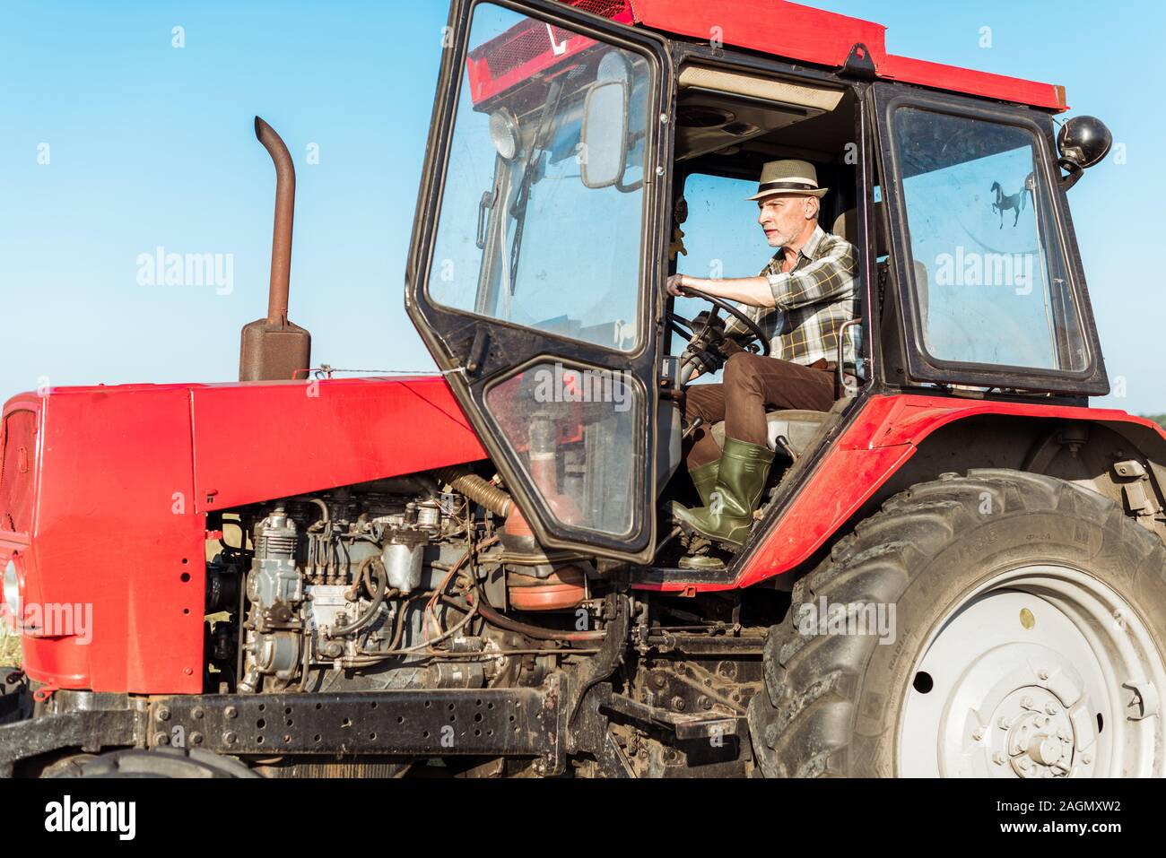 Senior farmer driving tractor hi-res stock photography and images - Alamy