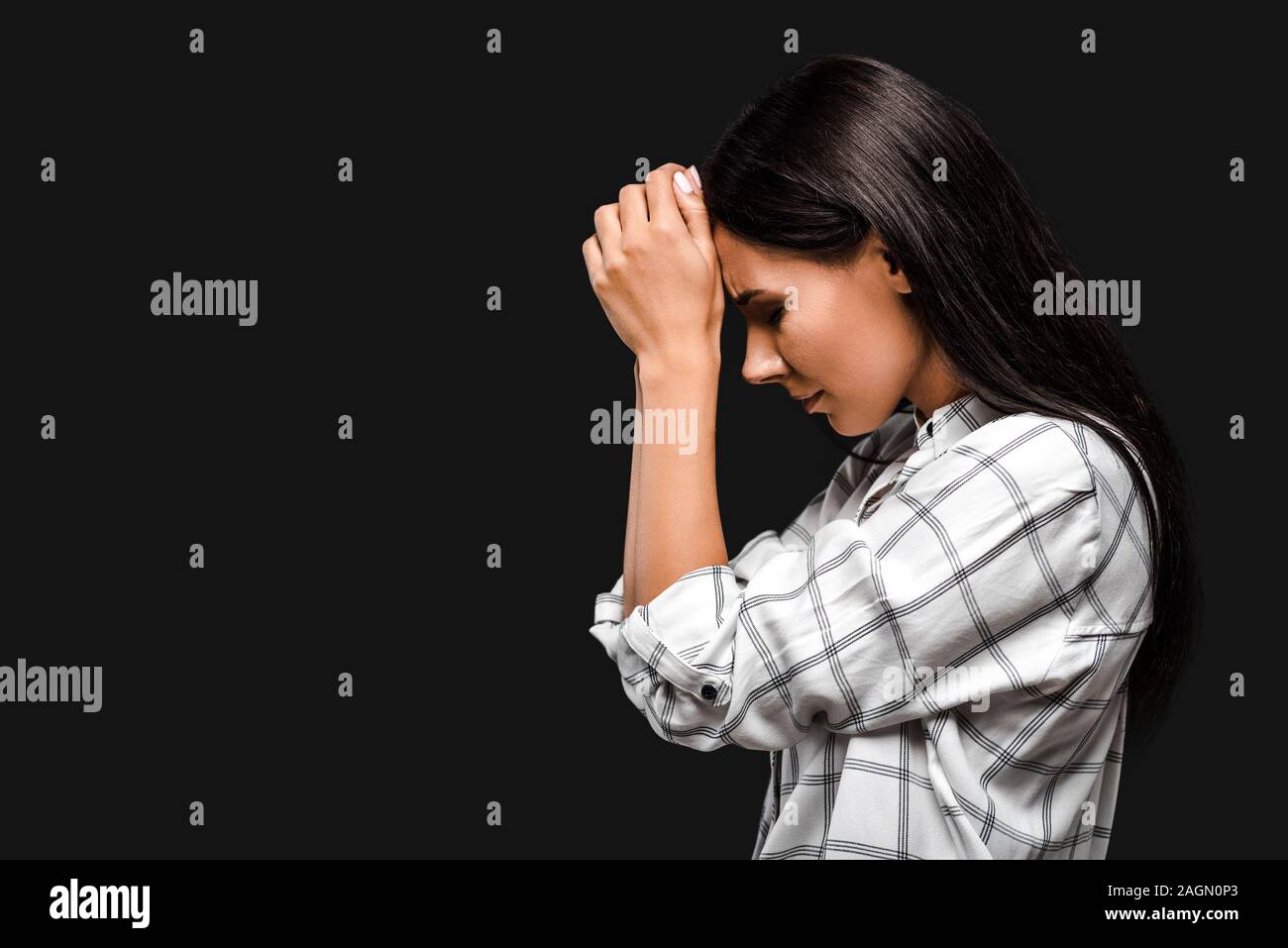 side view of upset young woman touching head isolated on black Stock Photo - Alamy