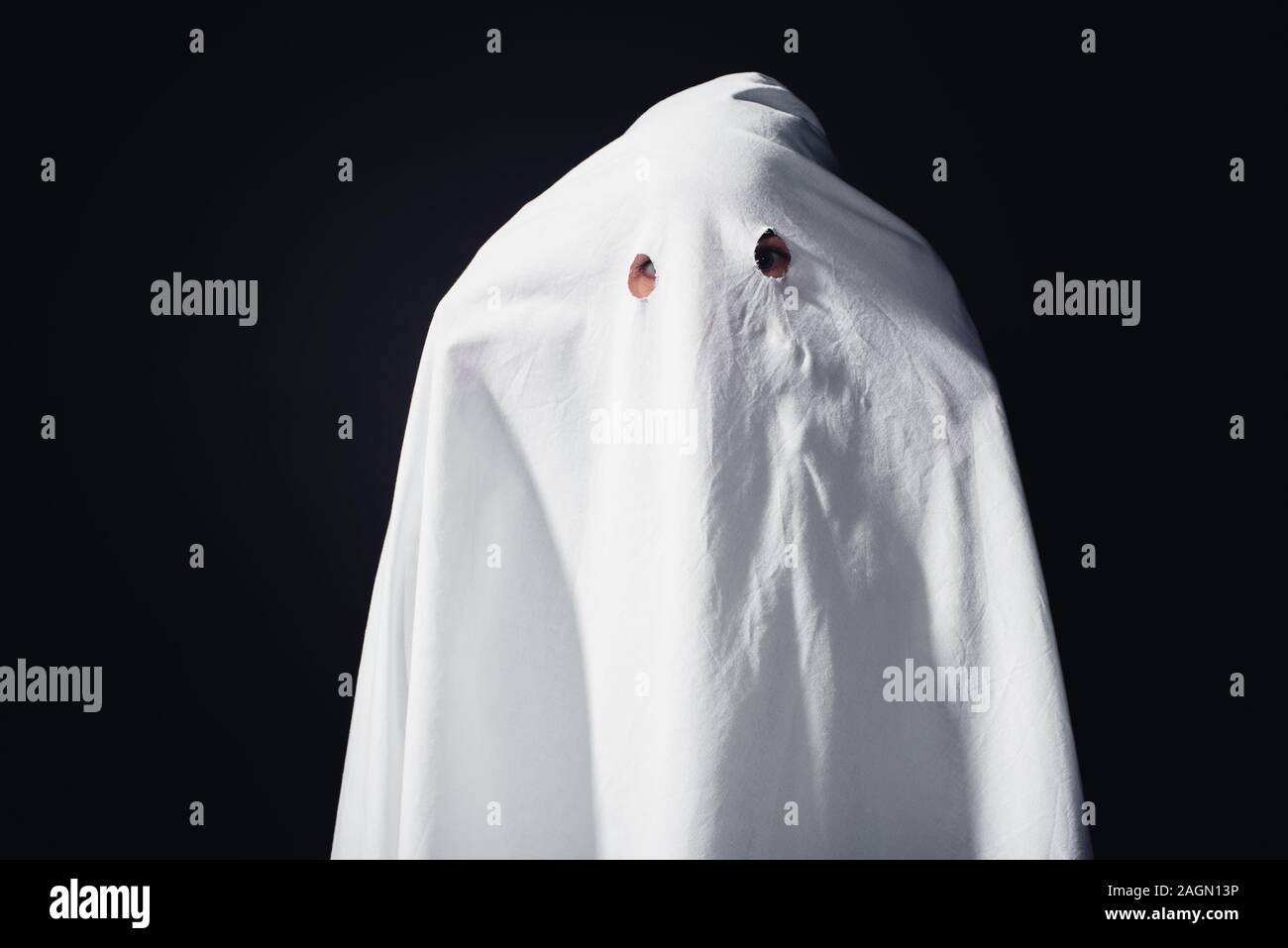 horrible ghost in white bedsheet isolated on black Stock Photo - Alamy