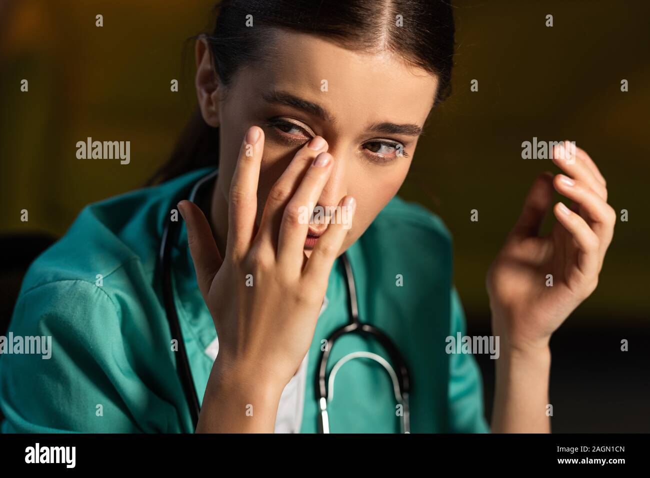 attractive and tired nurse in uniform crying during night shift Stock ...