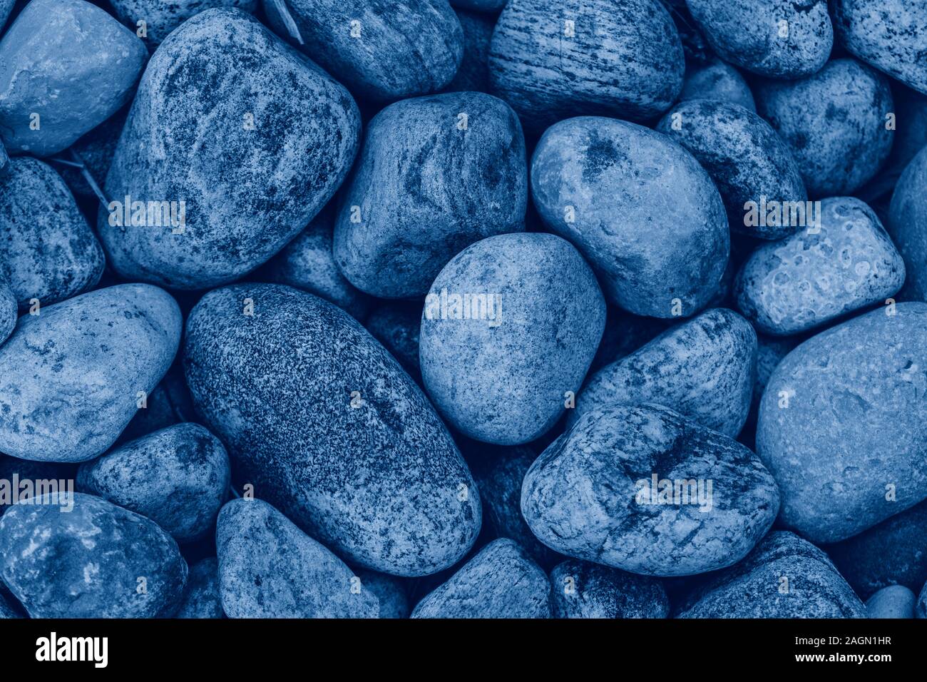 Closeup macro of big huge large blue stones rocks pebbles lying on ...