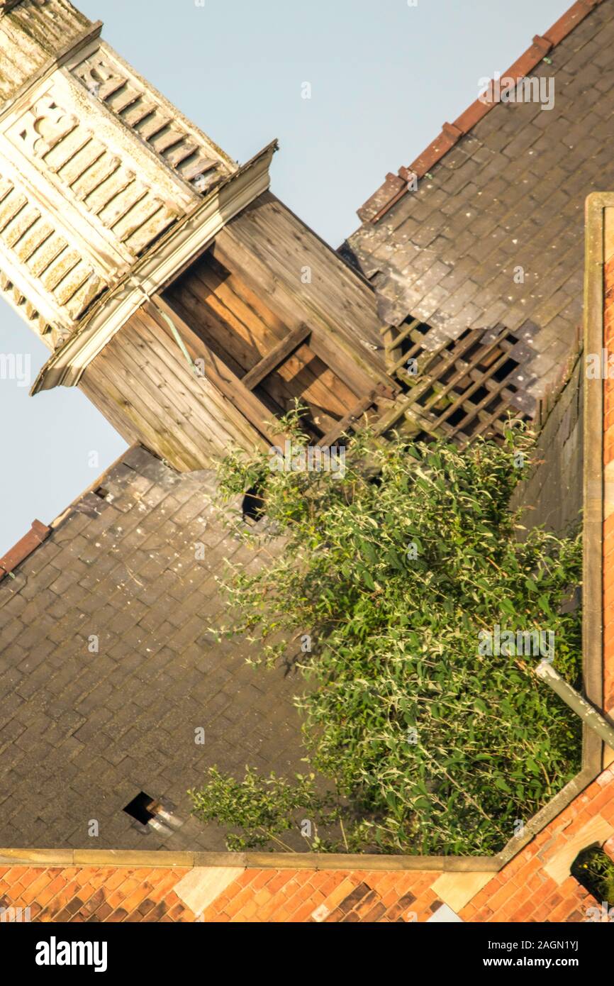 An abandoned school tower sits open to the elements. Heavy damage ...