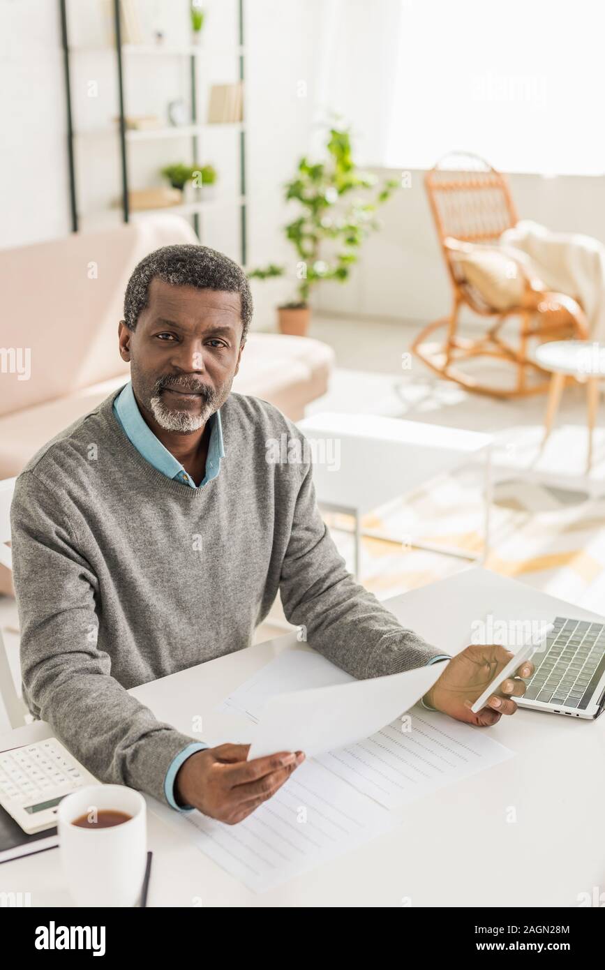 serious african american man looking at camera while holding utility ...