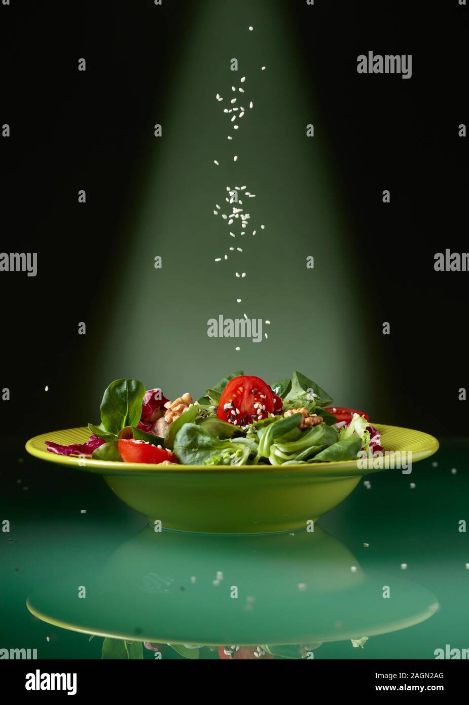 Green salad with tomatoes, walnuts and vegetable oil sprinkle with ...