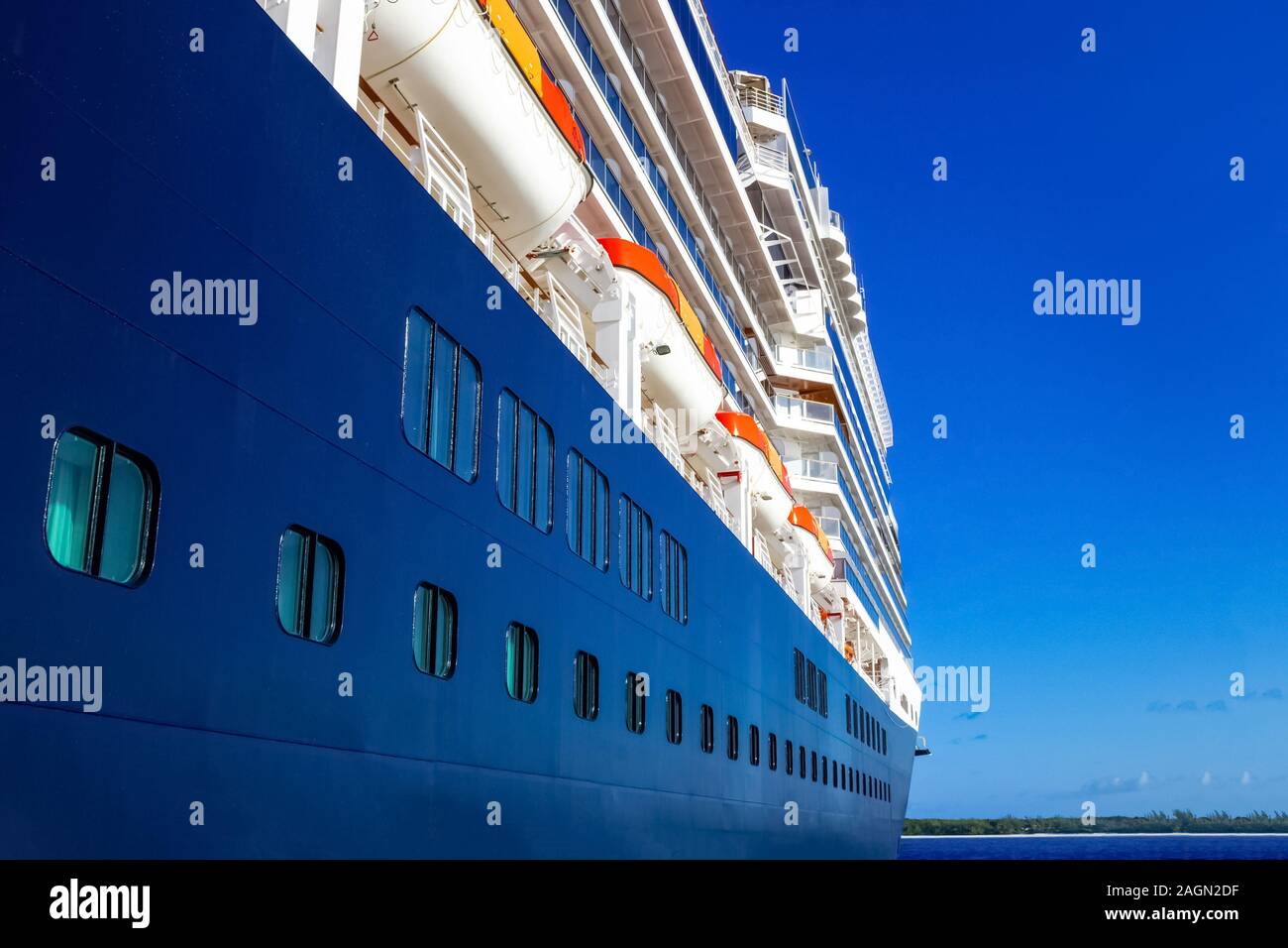 A view of a large cruise ship docked along the waterfront of Bahamas ...