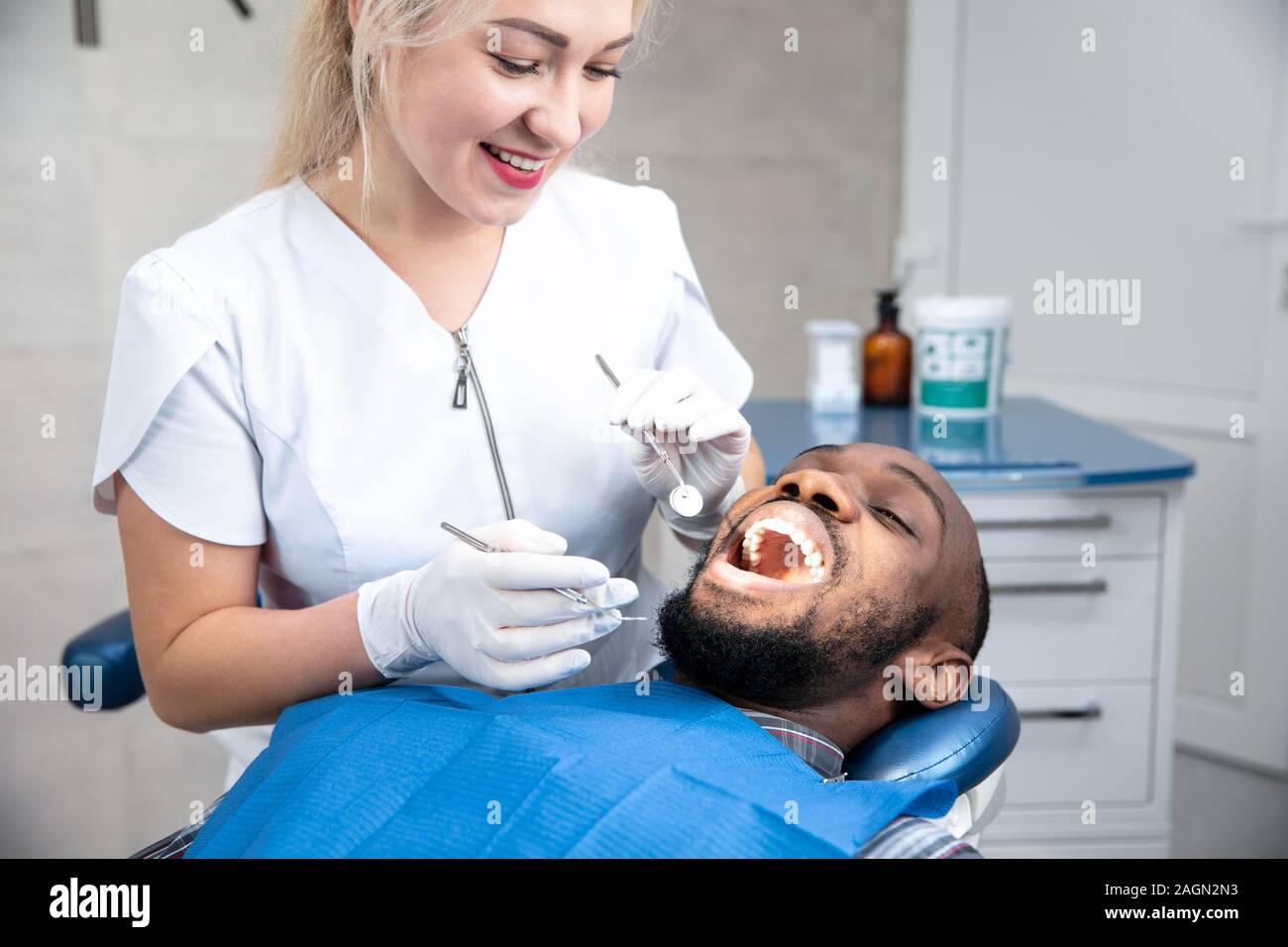 Young african-american man visiting dentist's office for prevention and ...