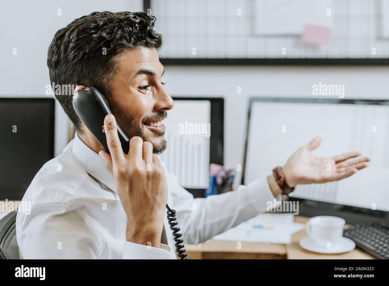 side view of smiling bi-racial trader talking on telephone Stock Photo ...