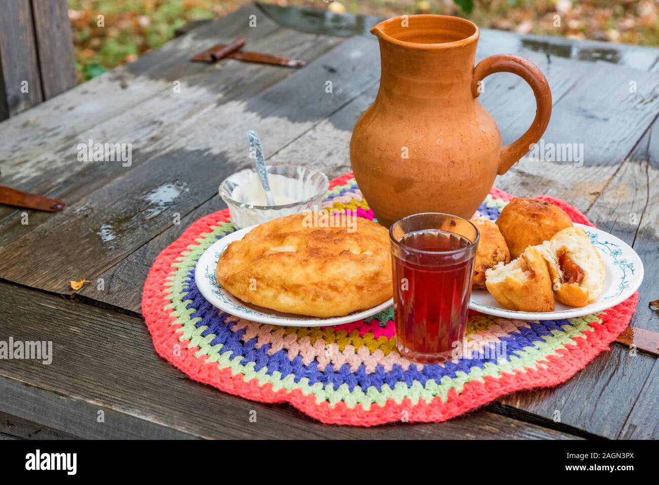Close up of traditional cossack meal with stuffed pies and berry drink ...