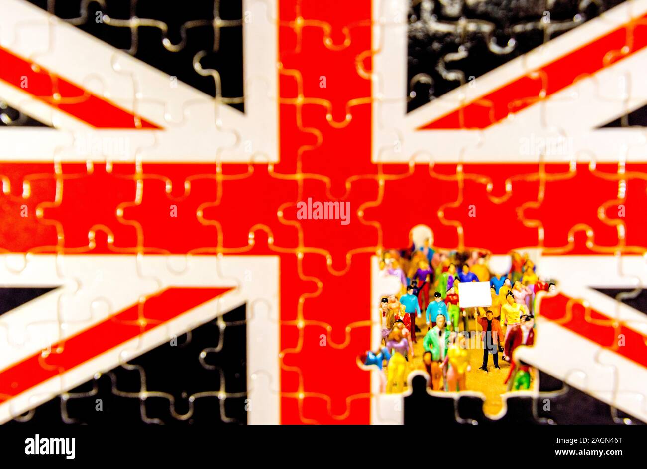 Crowds of protesters stand behind the Union Jack flag of the United ...