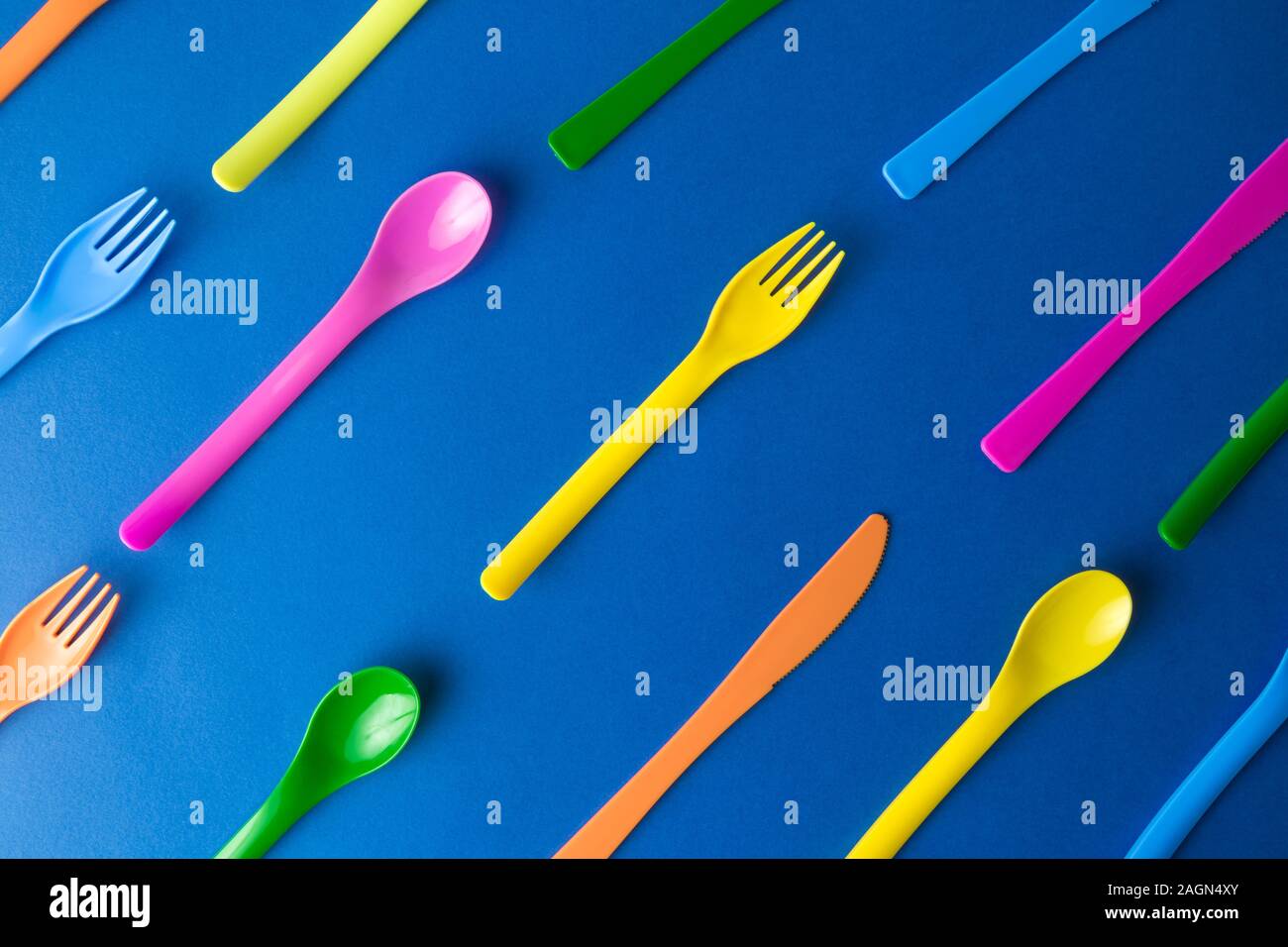 Flat lay of colorful plastic disposable forks,spoons and knives pattern ...