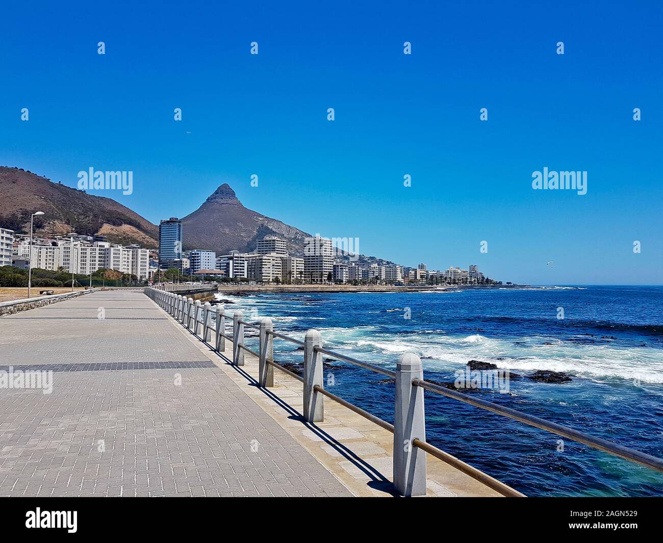 Mountains, hotels and deep blue water with waves at the Sea Point ...