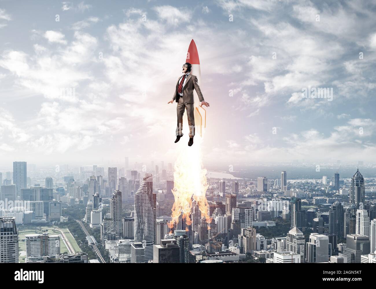 Business person in aviator hat flying on rocket Stock Photo - Alamy