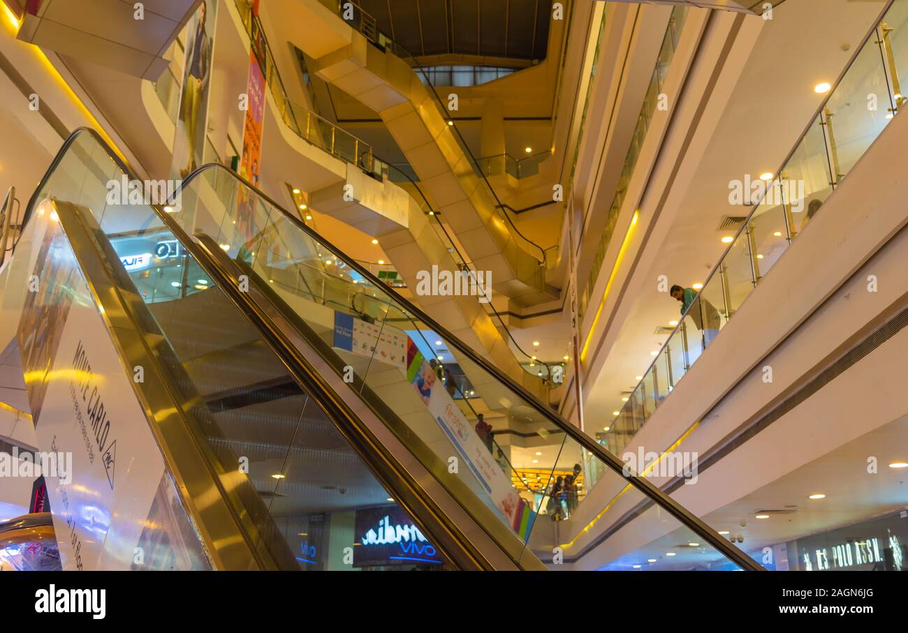 Modern city shopping complex interior view with connecting escalators ...