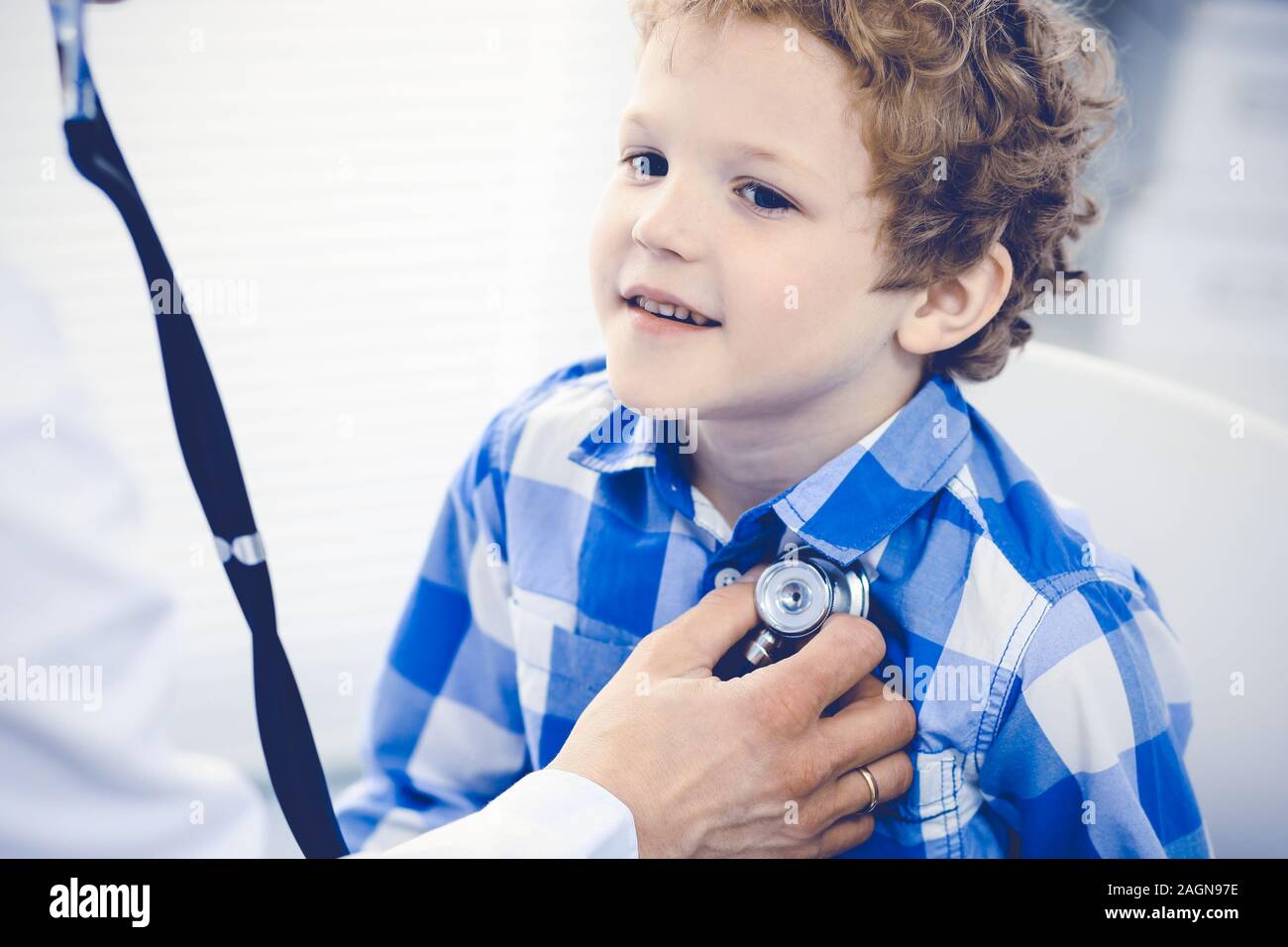 Doctor and patient child. Physician examining little boy. Regular ...