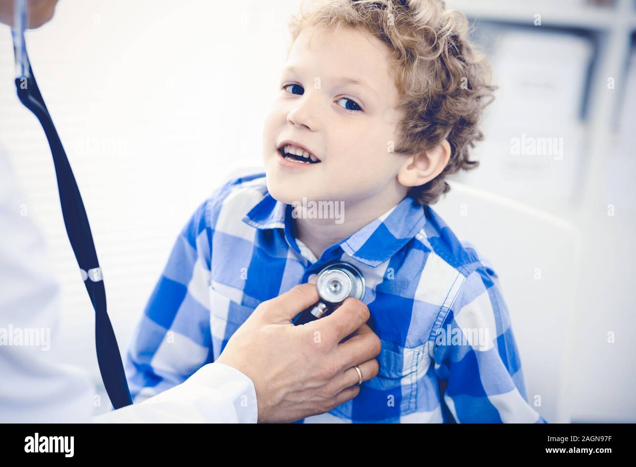 Doctor and patient child. Physician examining little boy. Regular ...