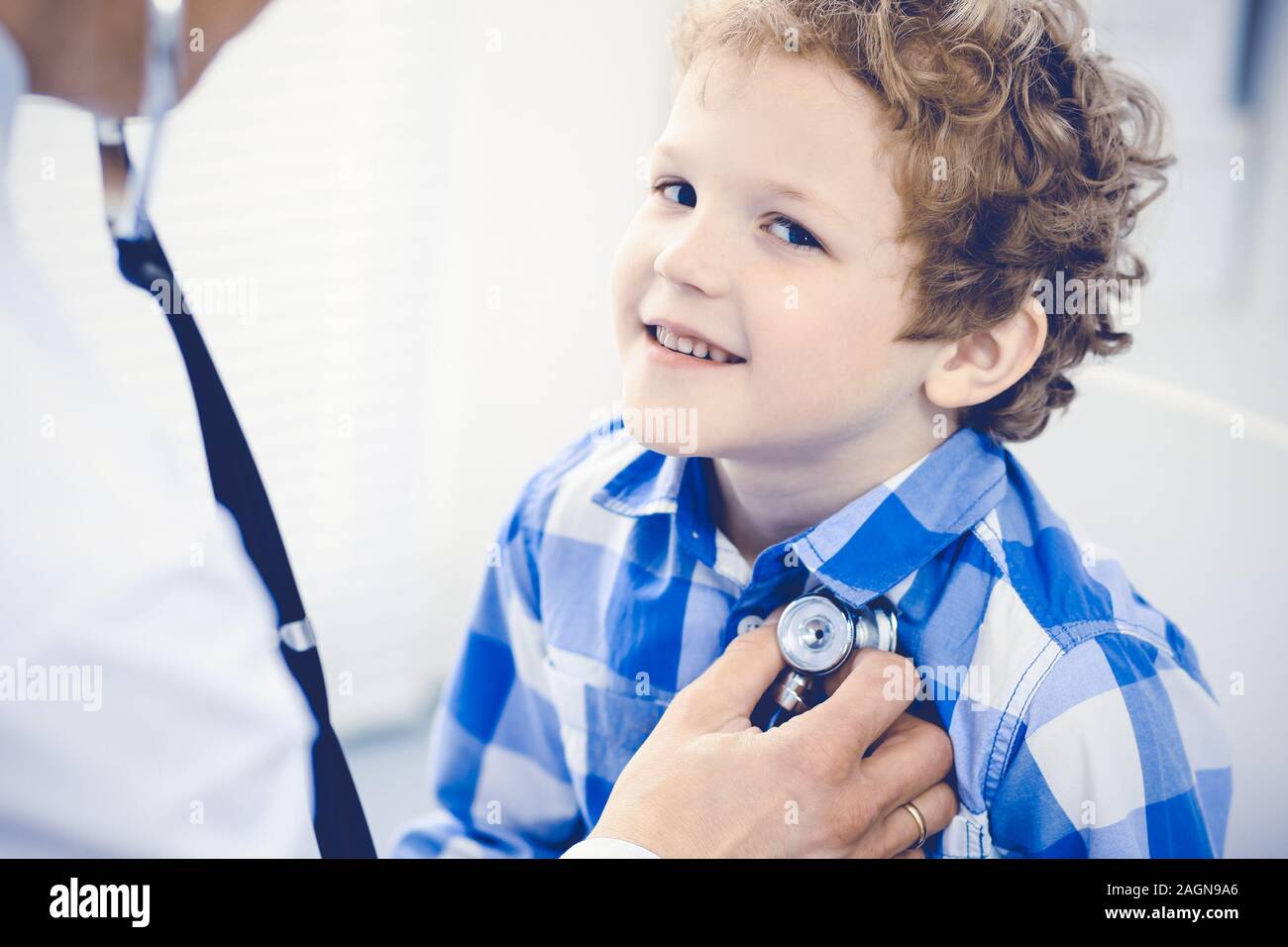 Doctor and patient child. Physician examining little boy. Regular ...