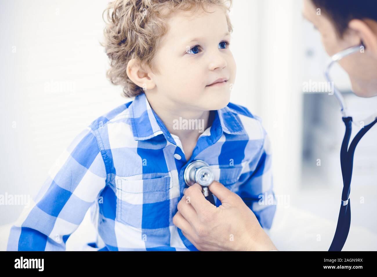 Doctor and patient child. Physician examining little boy. Regular ...