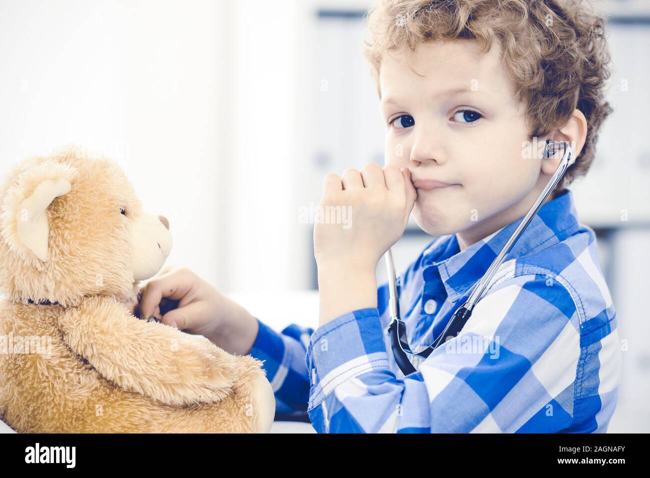 Doctor and patient child. Physician examining little boy. Regular ...