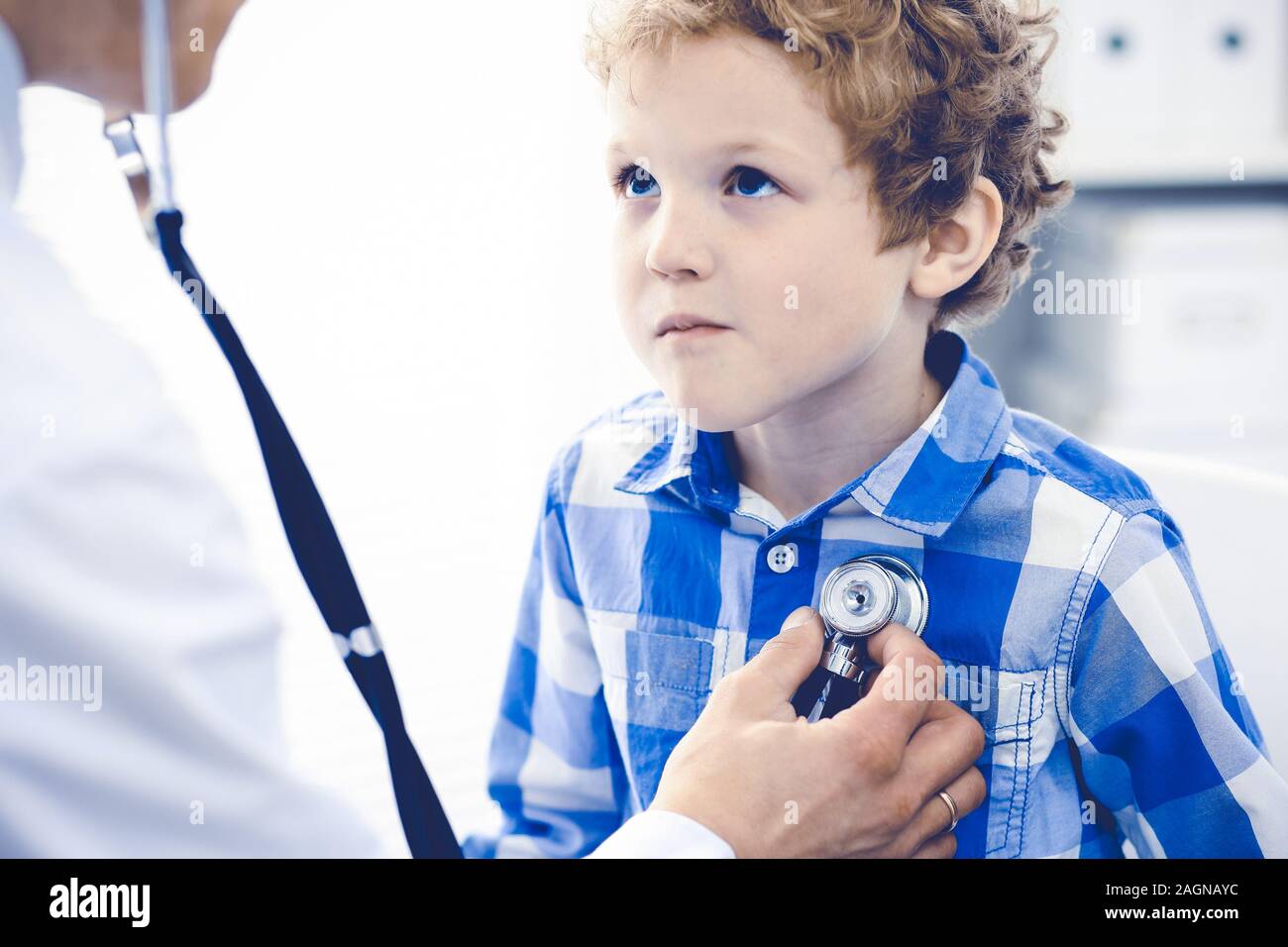 Doctor and patient child. Physician examining little boy. Regular ...