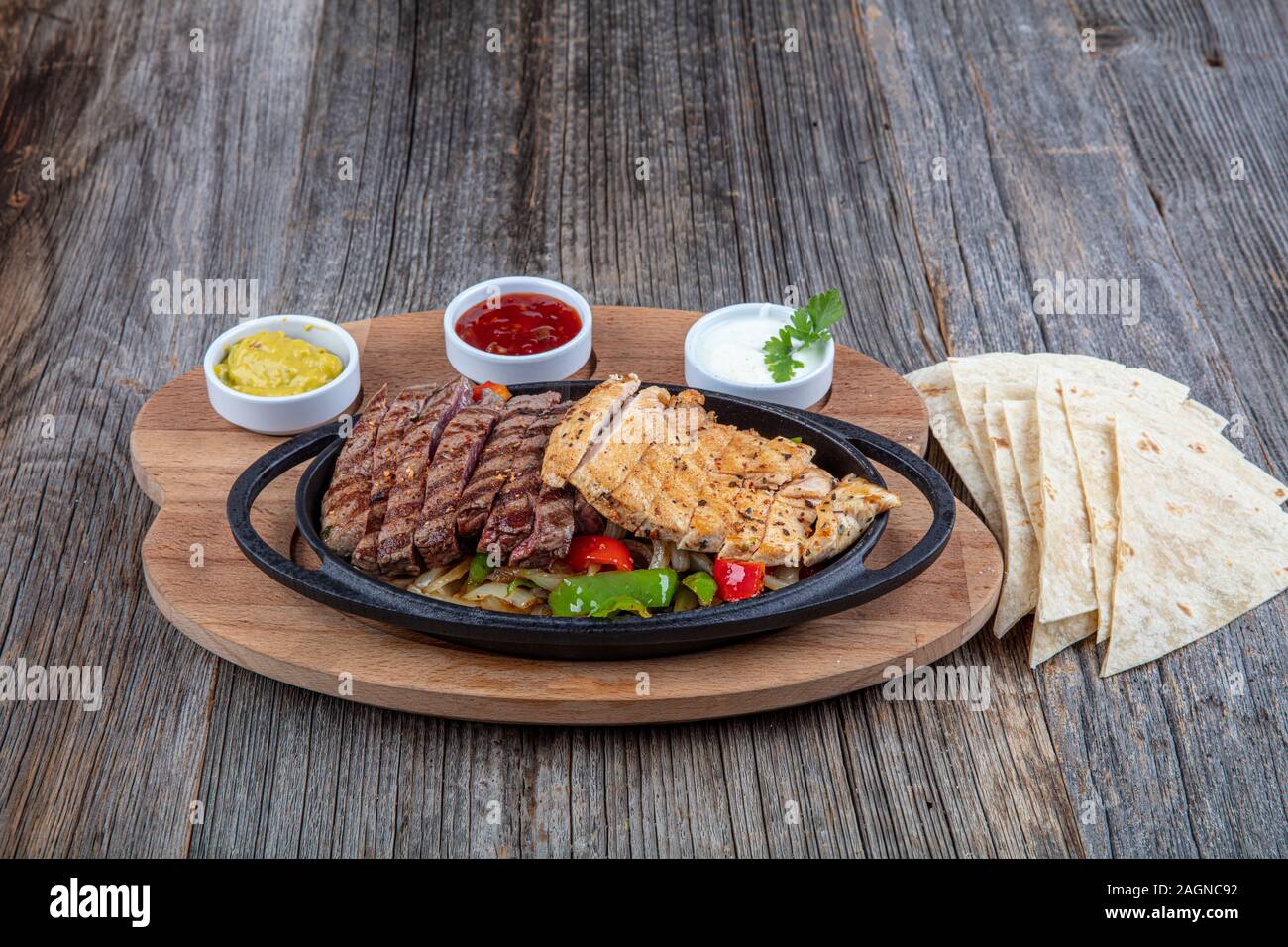 Combo Fajita; mexican steak and chicken fajitas in iron skillet with ...