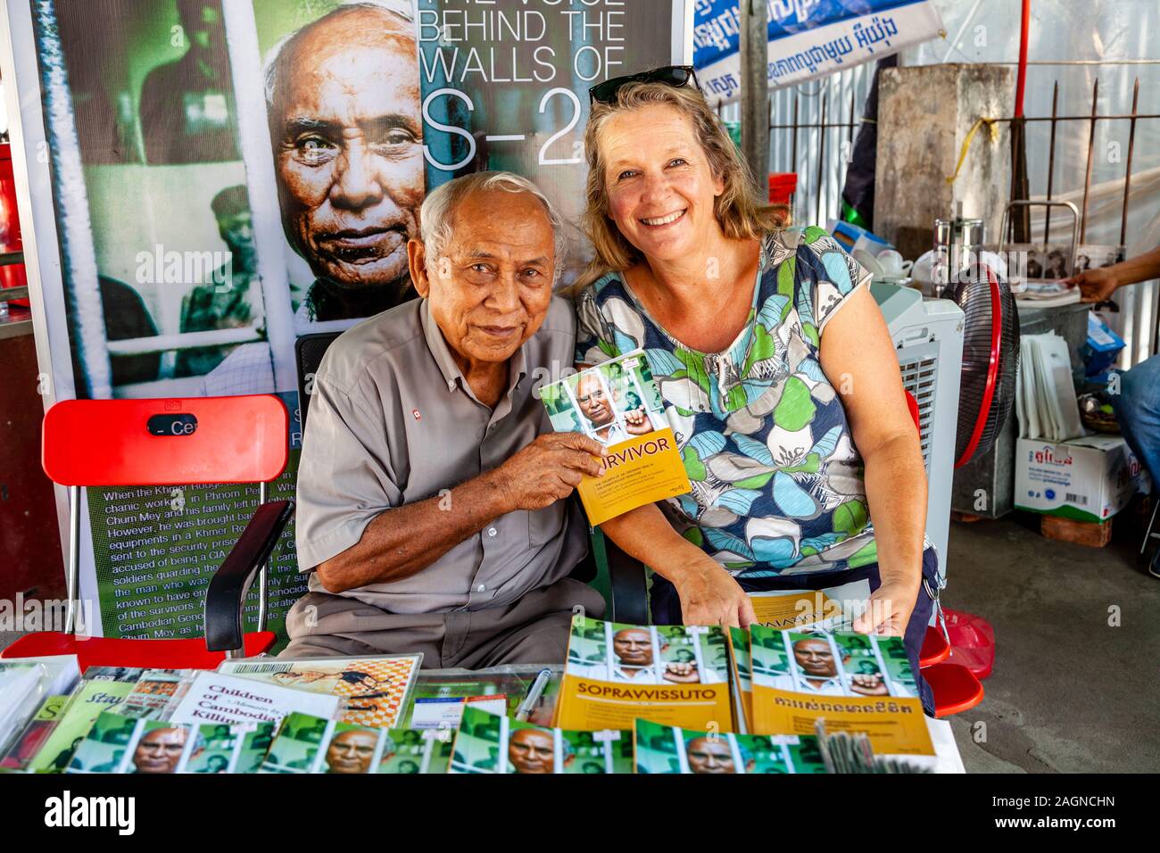 Prison Survivor Chum Mey Poses With A Female Tourist With His Book ...