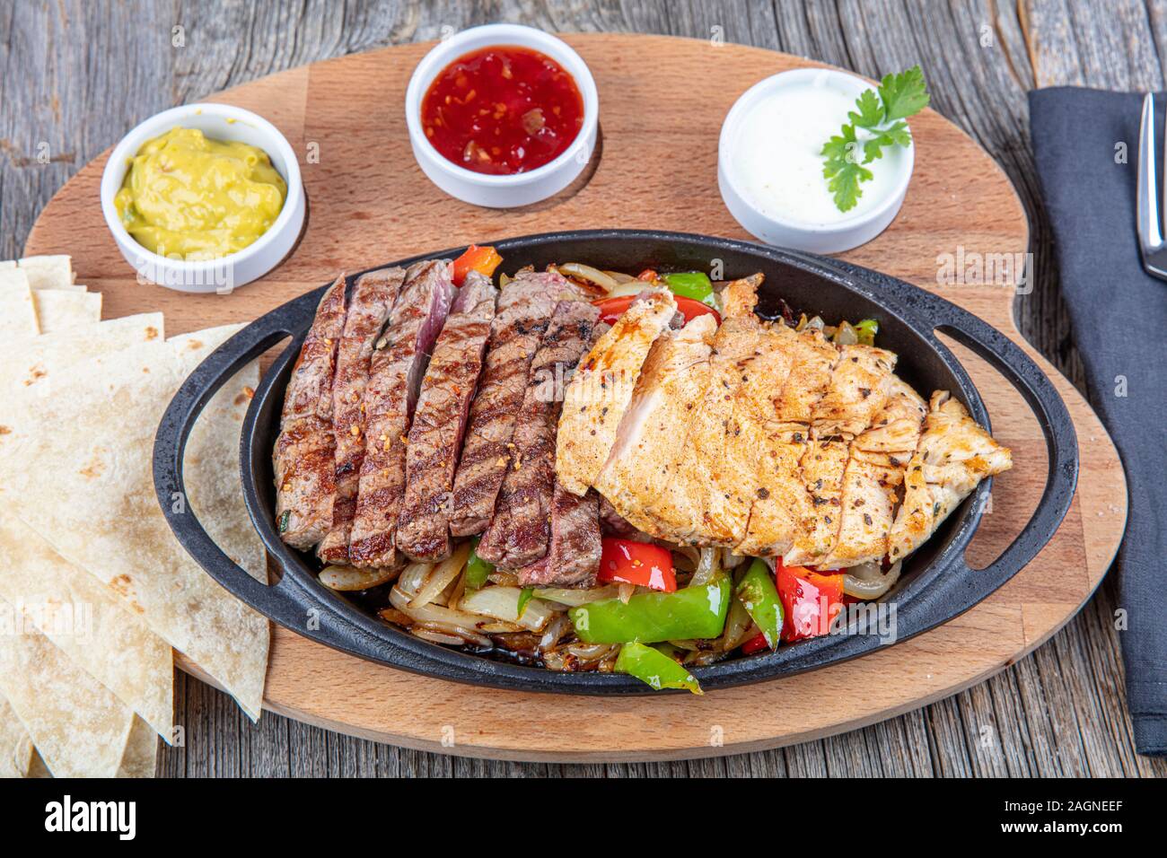 Combo Fajita; mexican steak and chicken fajitas in iron skillet with ...