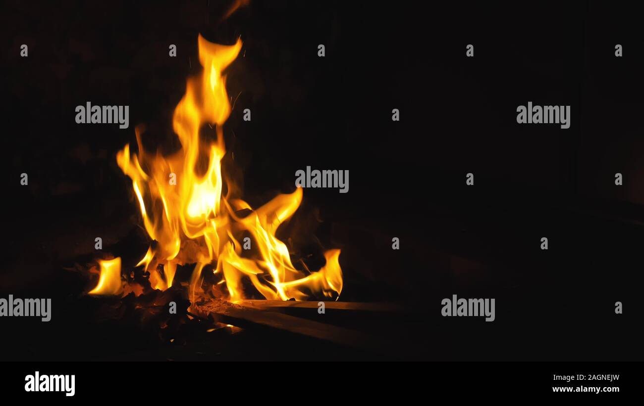 Forge fire in furnace. Blacksmith tempers a steel product in a stove ...