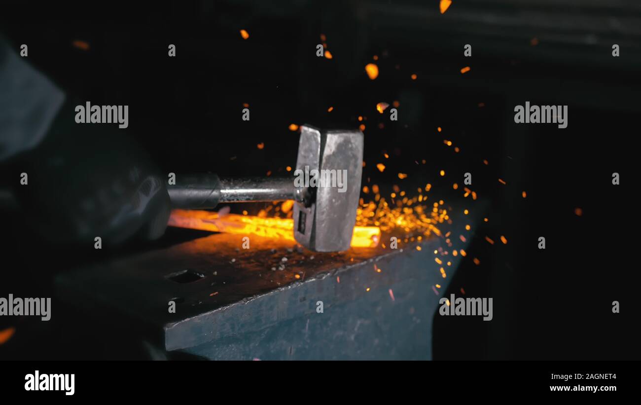 Forge workshop. Smithy manual production. Hands of smith with hammer ...