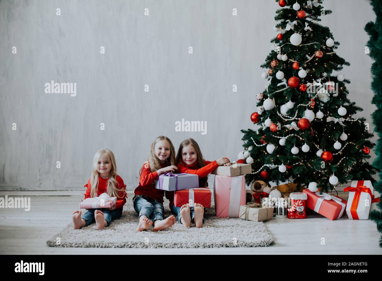 three girls blonde sisters girlfriends gift new year tree holiday ...