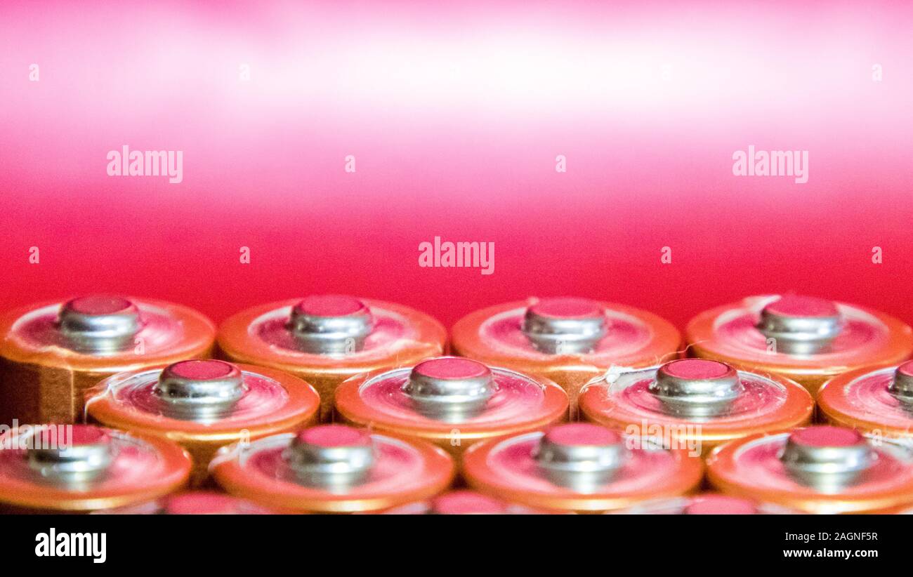 A collection of pencil AA batteries, taken close up at their heads ...