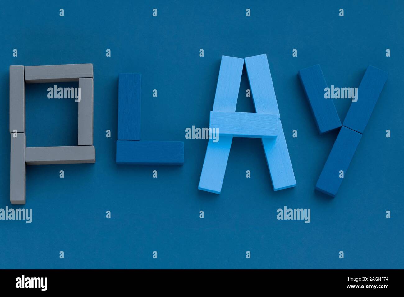 Word PLAY made from wooden bricks toys on blue background. Kids game ...
