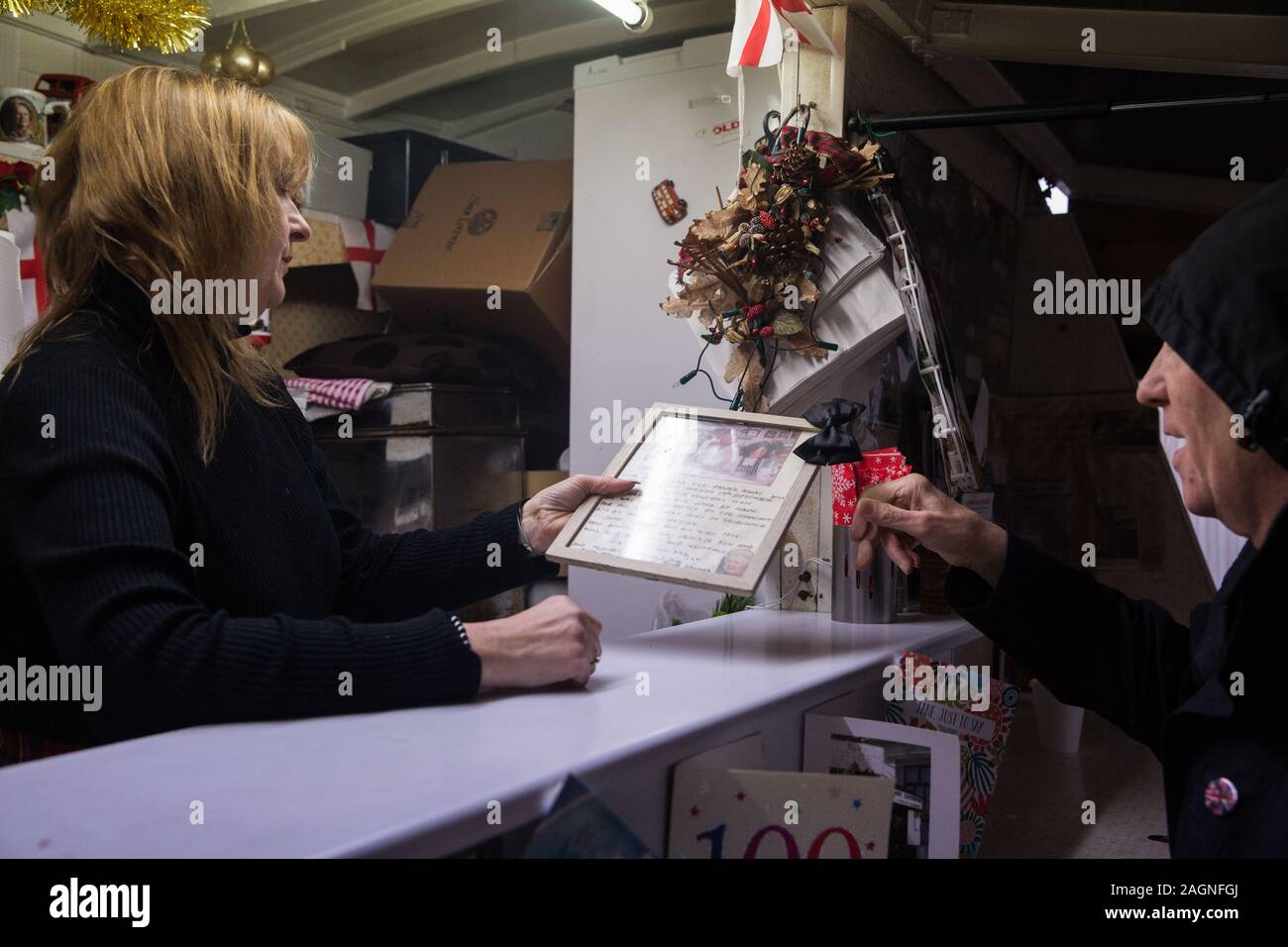 London, UK. 20 December, 2019. Cheryl Diamond looks at a photograph of ...