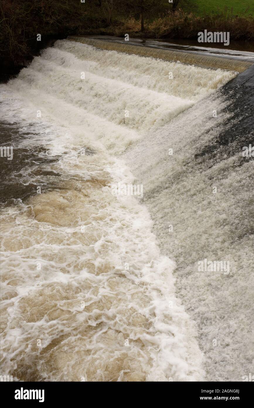 Fast flowing river irwell plunging over weir and aerating river ...