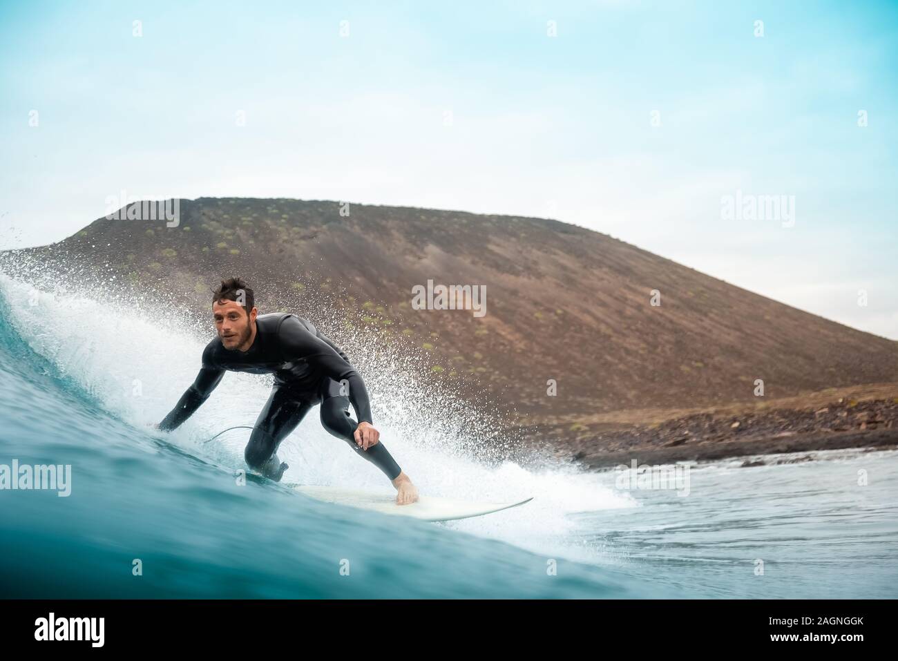 surfer riding waves on the island of fuerteventura Stock Photo - Alamy