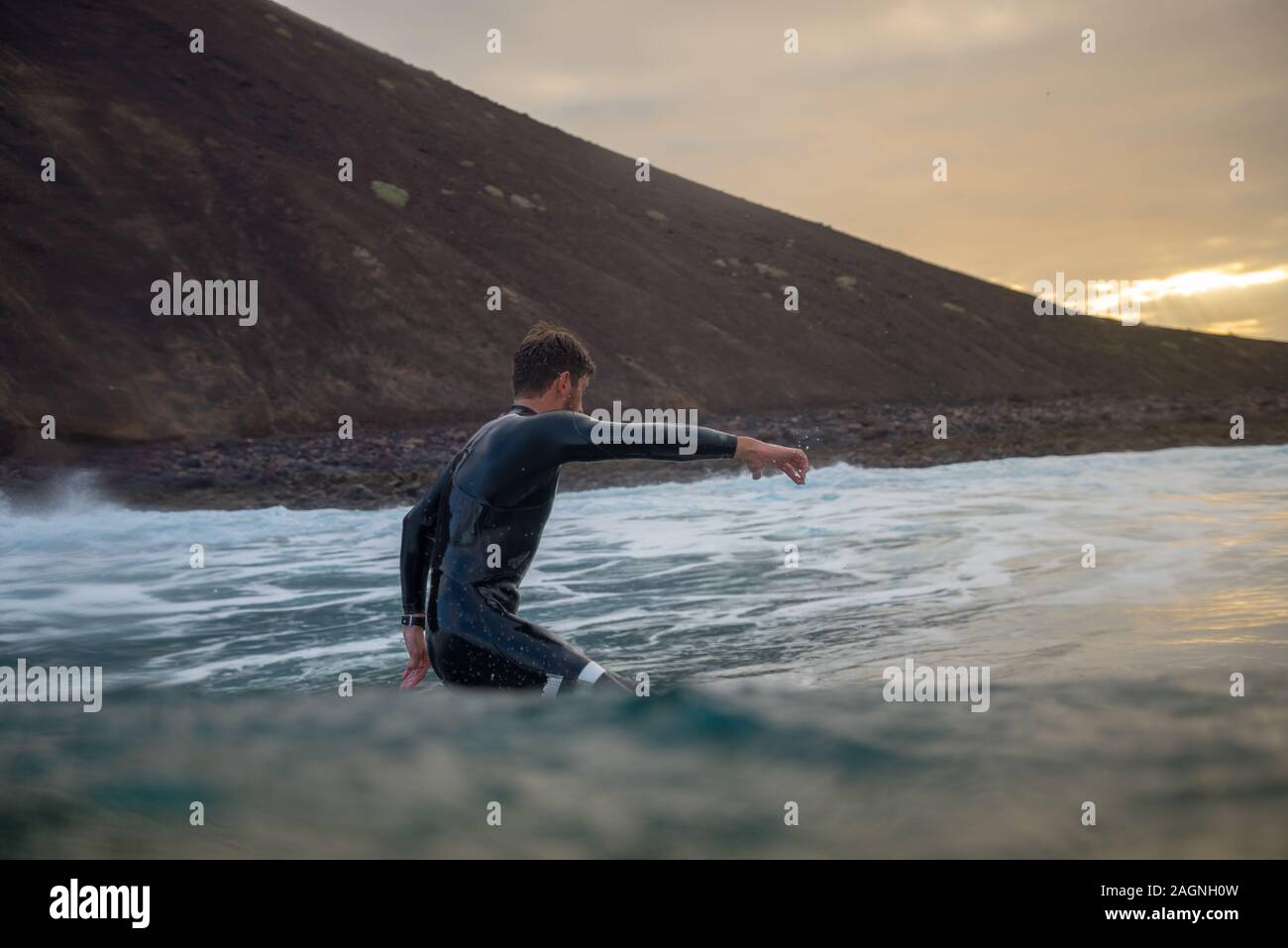 surfer riding waves on the island of fuerteventura Stock Photo - Alamy