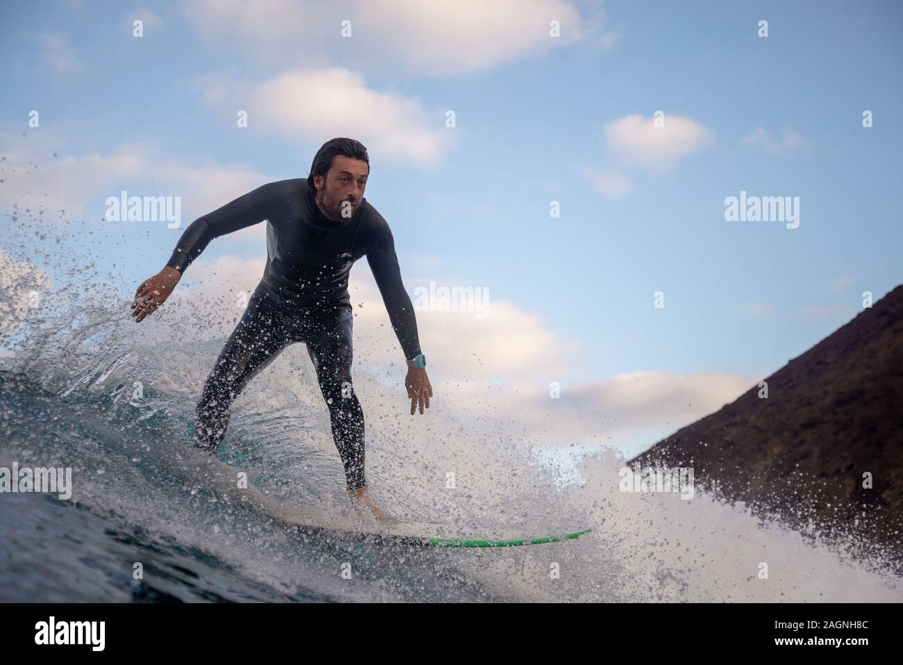 surfer riding waves on the island of fuerteventura Stock Photo - Alamy