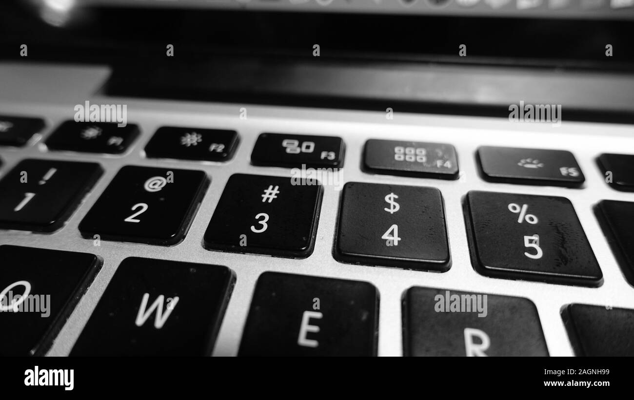 Laptop or notebook computer keyboard keys close up. Black and white ...