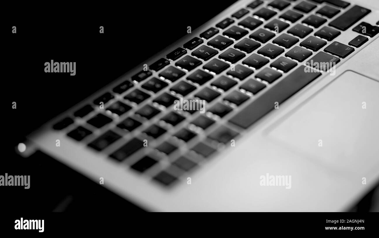 Black and white laptop or notebook computer keyboard keys close up ...